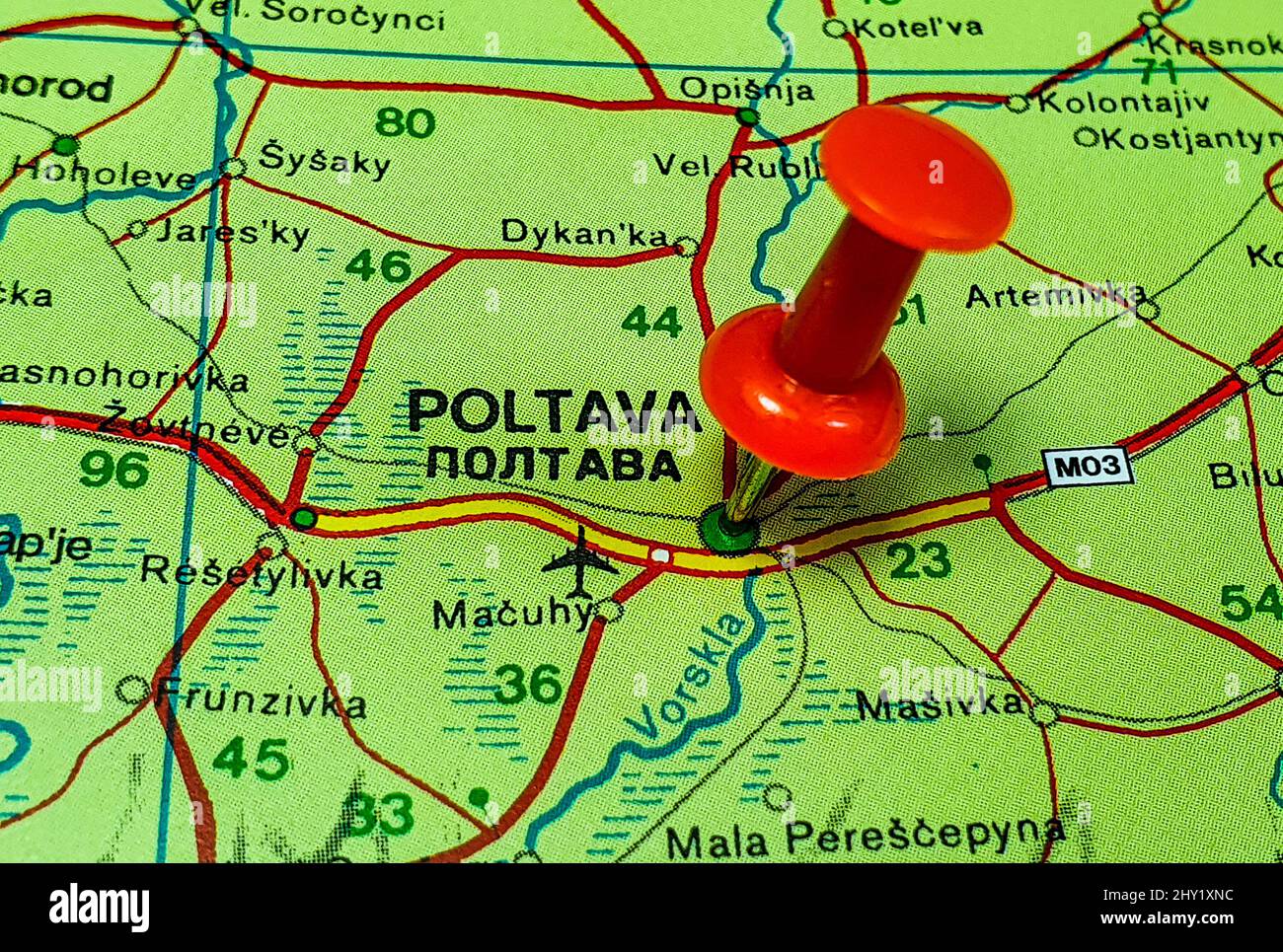 Red pin on a green world map pointing on the Poltava city in Ukraine ...