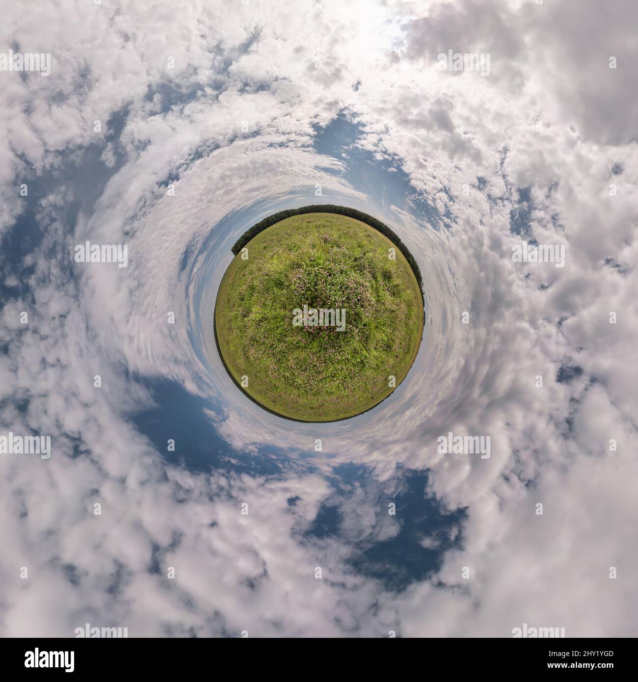 green tiny planet in blue sky with beautiful clouds. Transformation of ...