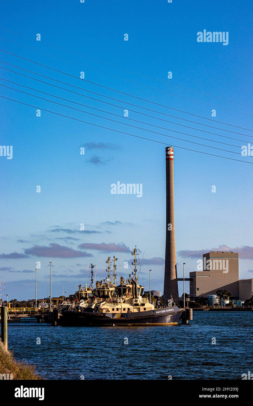 Beautiful view of a boat next to a factory Stock Photo - Alamy