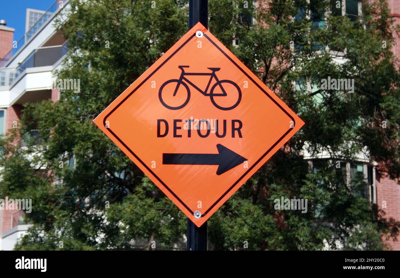 Bicycle detour sign with arrow pointing right in downtown Vancouver Stock Photo - Alamy