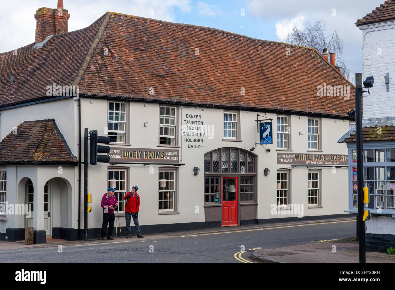 Overton village, Hampshire, England, UK, with two walkers on the High ...