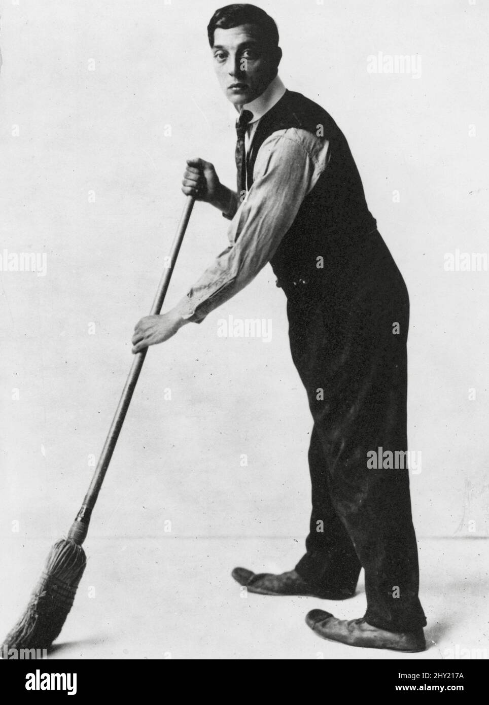 Silent film star Buster Keaton, sweeping up with a broom, circa 1921 ...