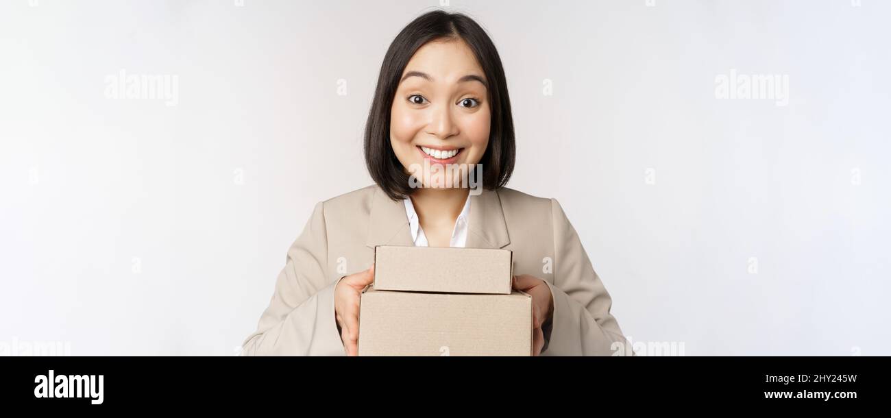Image of asian saleswoman, business woman giving boxes with order ...