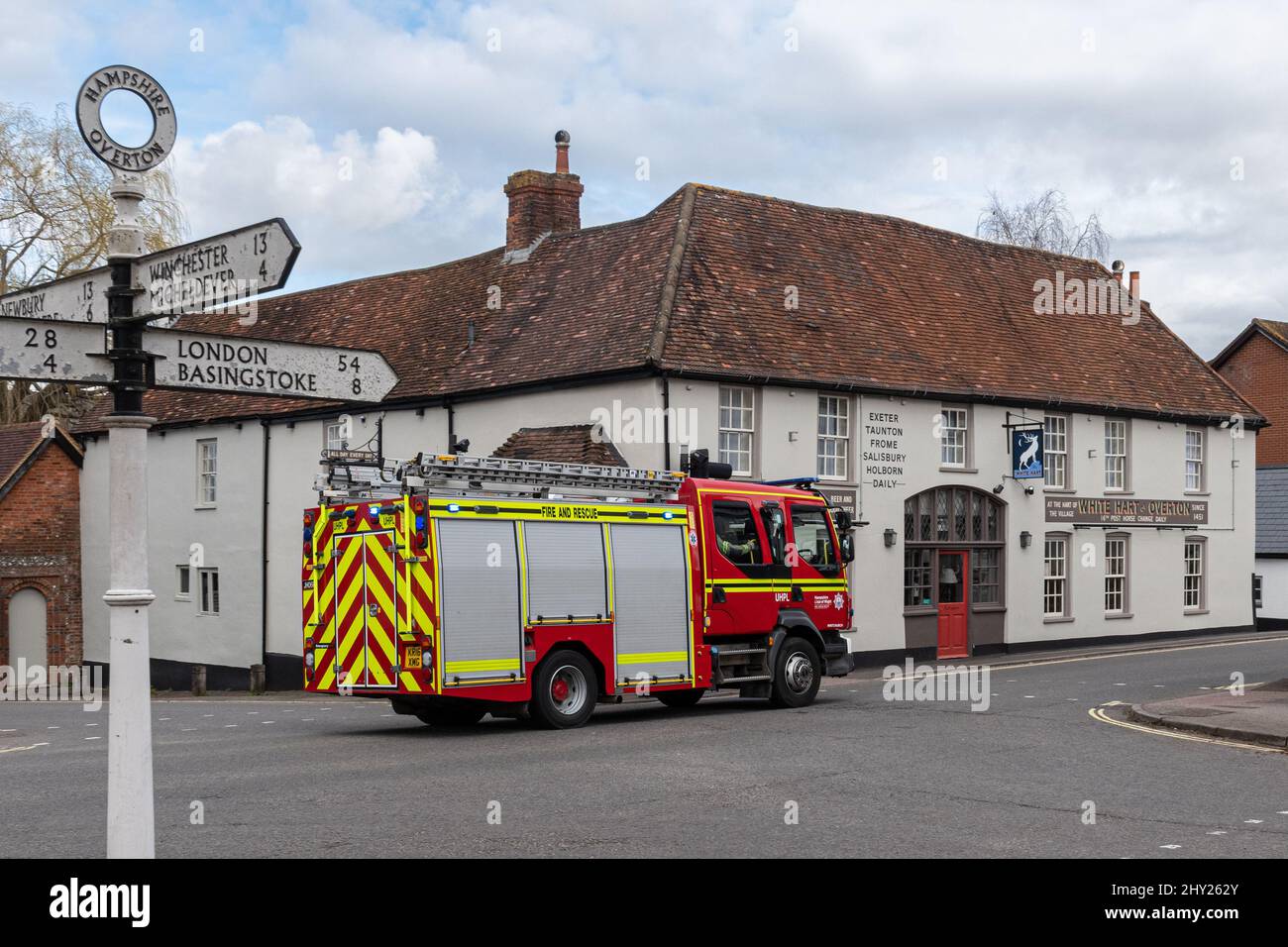 Fire engine driving through the centre of Overton, a large Hampshire ...