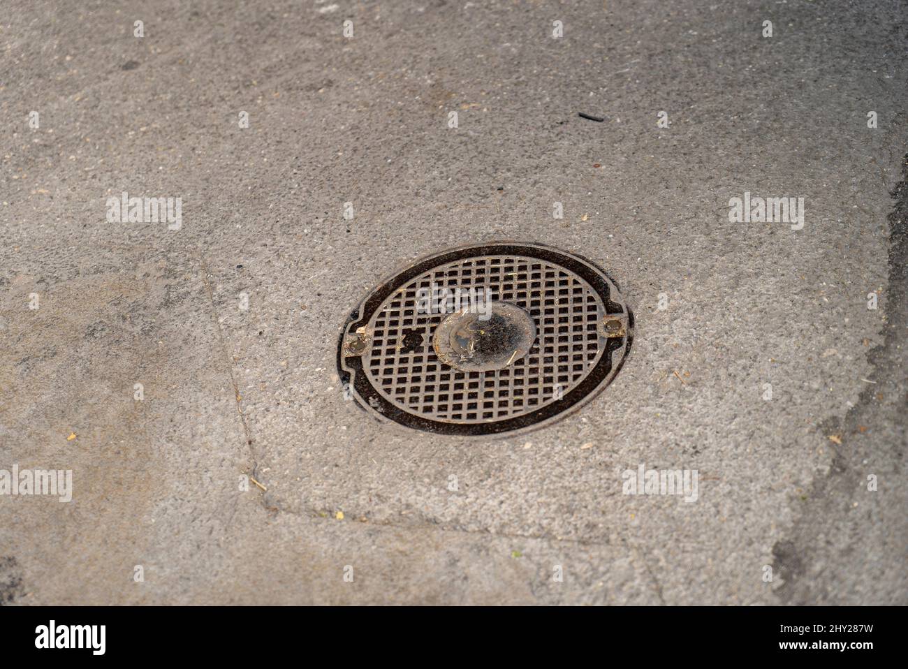 Weathered drainage hole on a street Stock Photo - Alamy