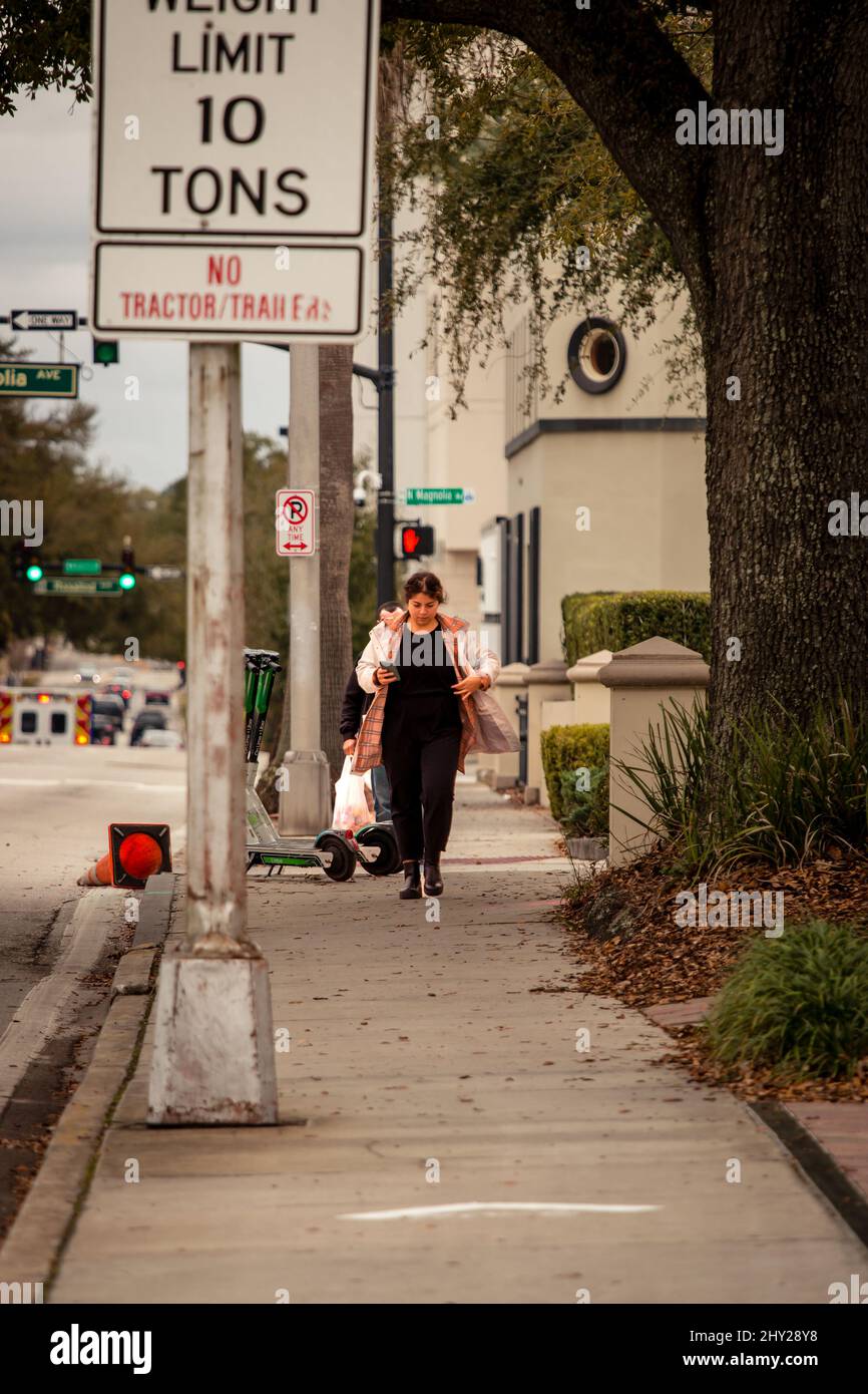 Photo of woman going down the street Stock Photo - Alamy