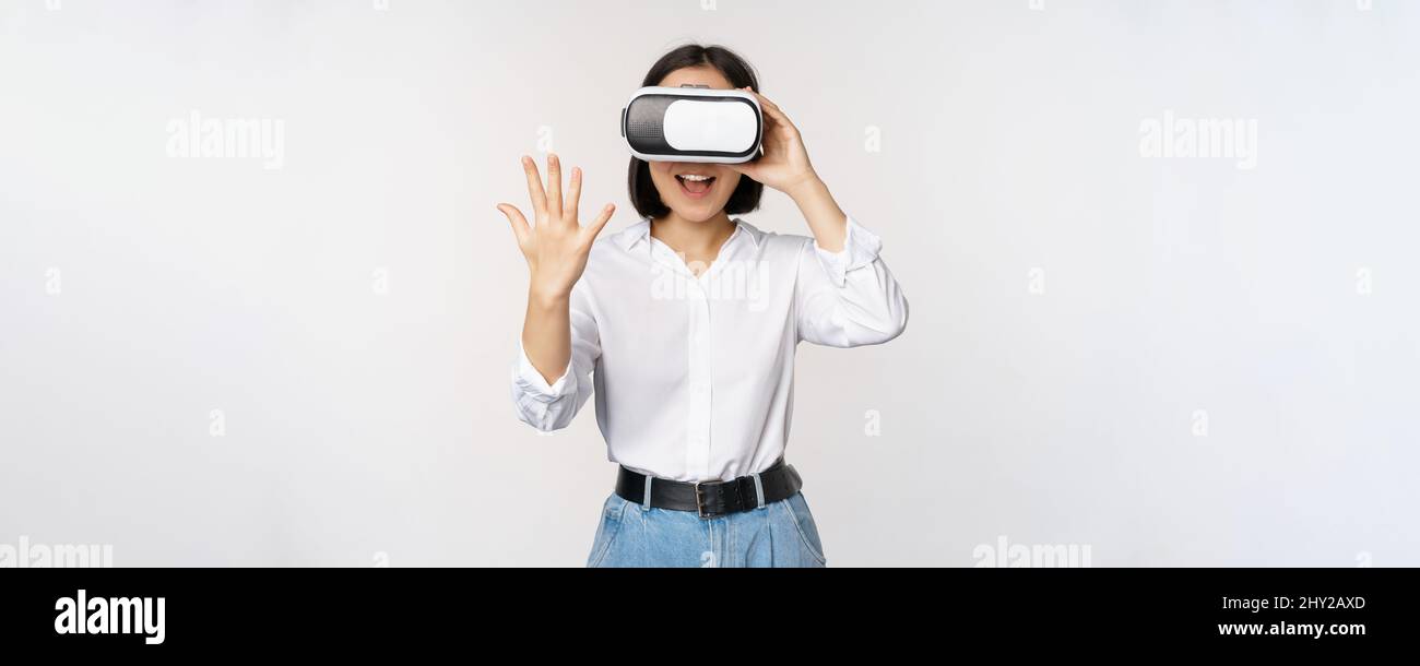 Vr chat. Asian girl saying hello in virtual reality glasses, smiling ...