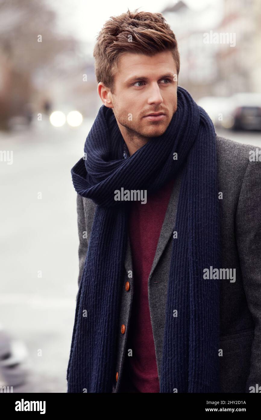 Classical male style. Shot of a stylish young man standing outside ...