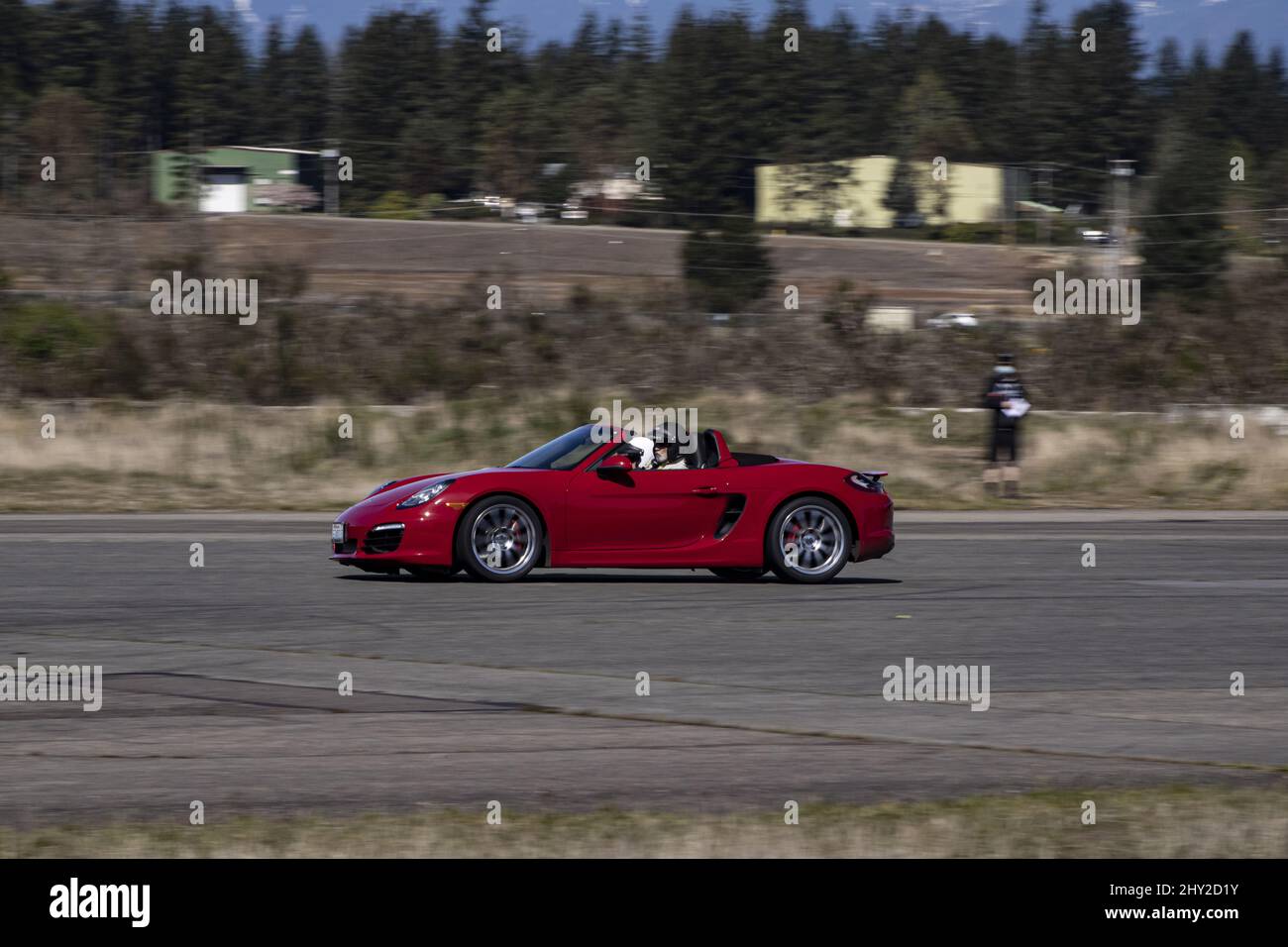 Red Porsche car racing on a runway in Washington Stock Photo - Alamy