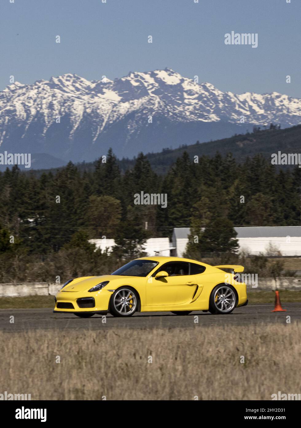 Yellow Porsche car racing on a runway in Washington Stock Photo - Alamy