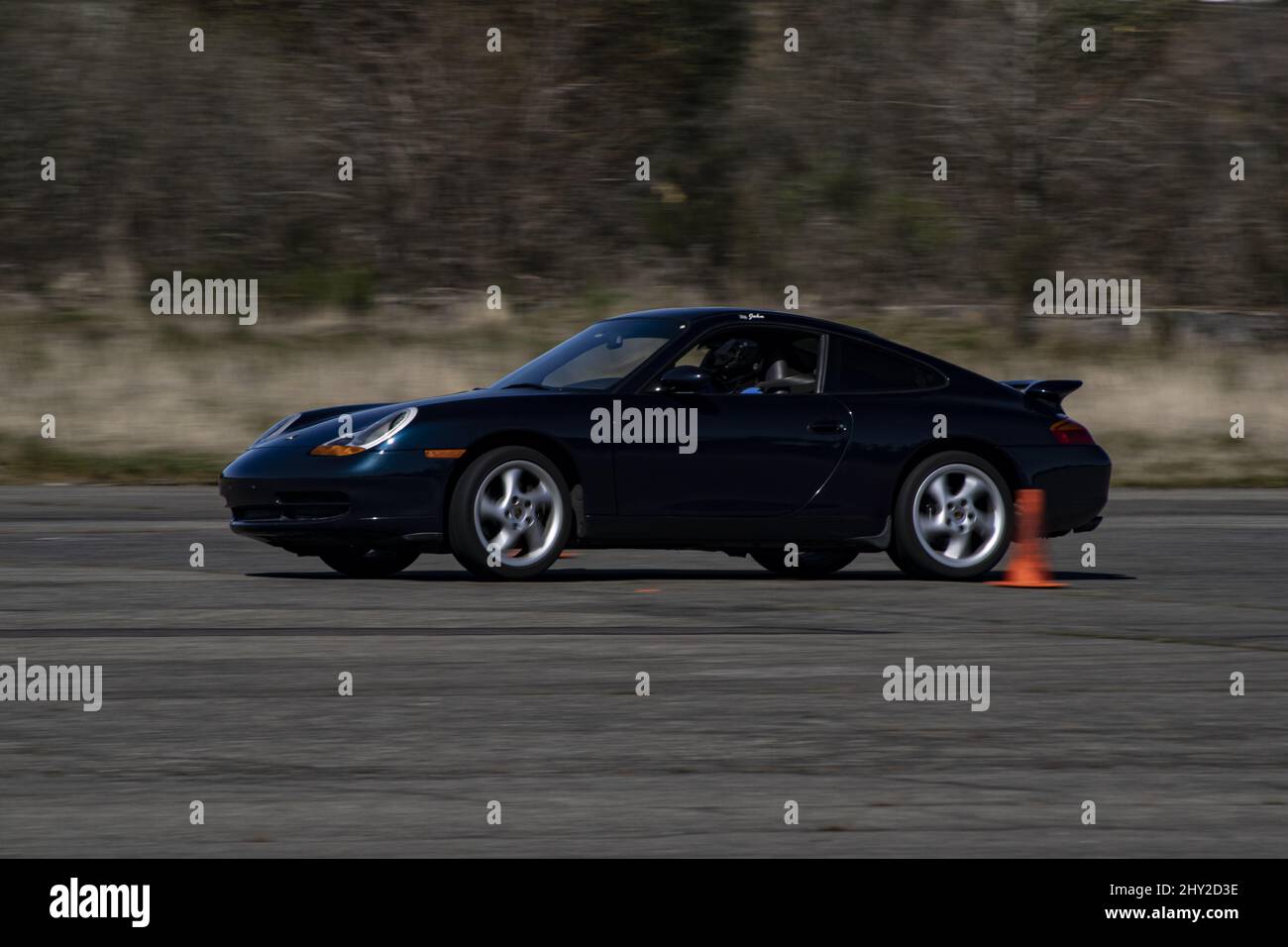 Blue Porsche car racing on a runway in Washington Stock Photo - Alamy