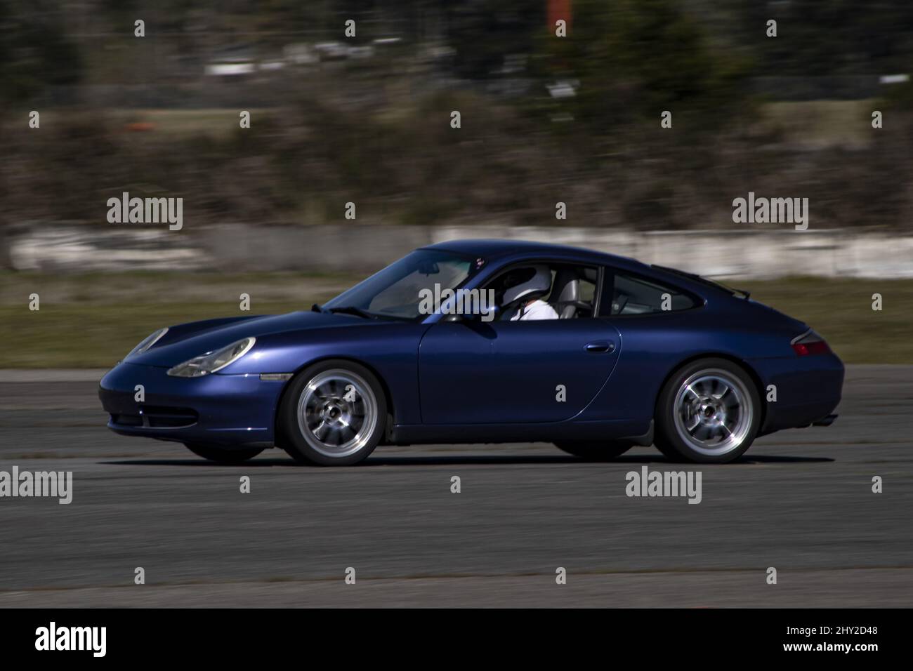 Blue Porsche car racing on a runway in Washington Stock Photo - Alamy