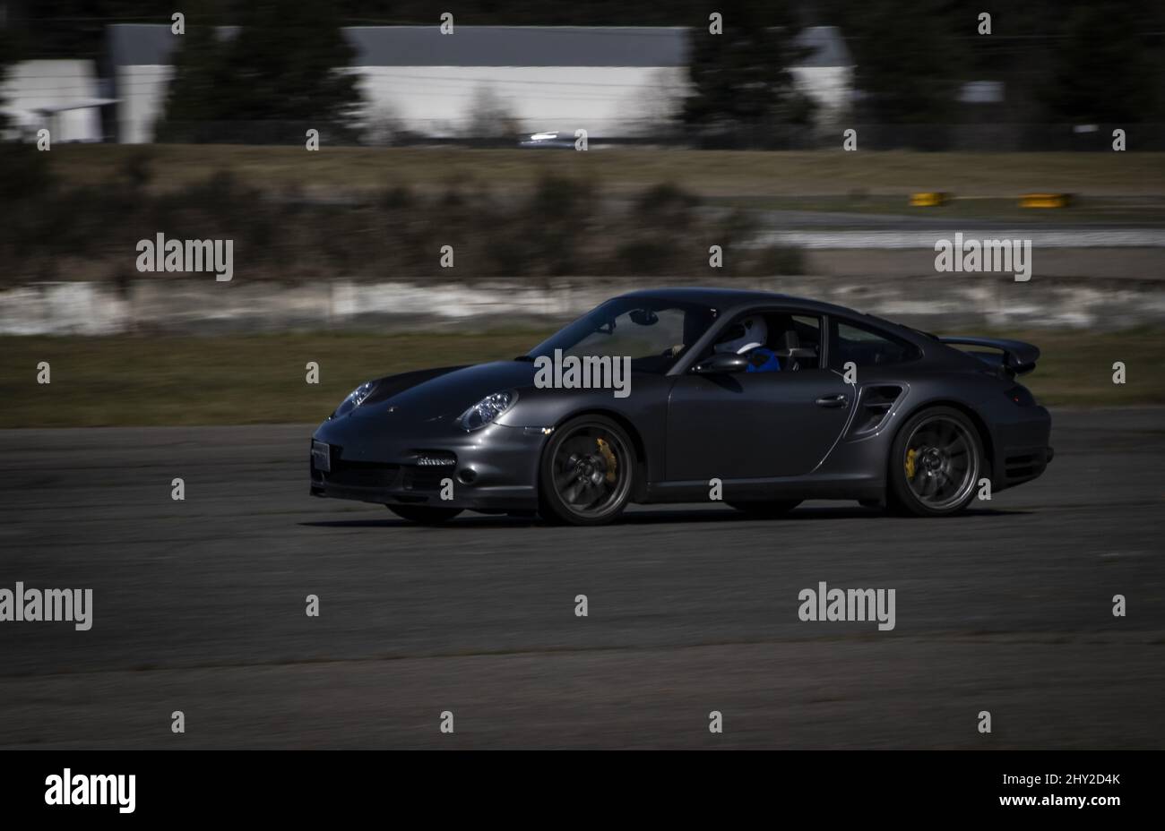 Black Porsche car racing on a runway in Washington Stock Photo - Alamy
