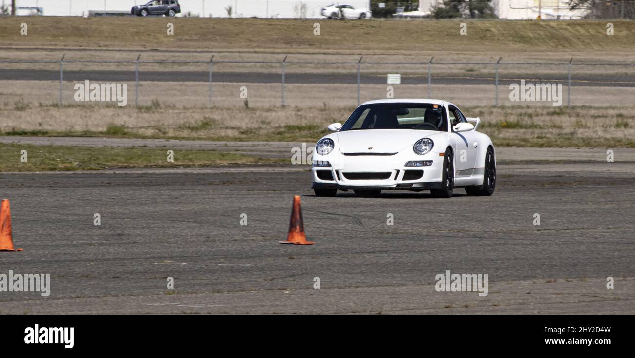 White Porsche car racing on a runway in Washington Stock Photo - Alamy