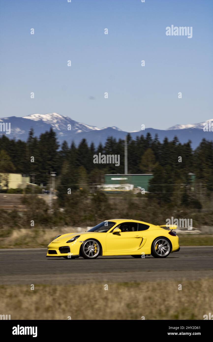 A Yellow Porsche car racing on a runway in Washington Stock Photo - Alamy
