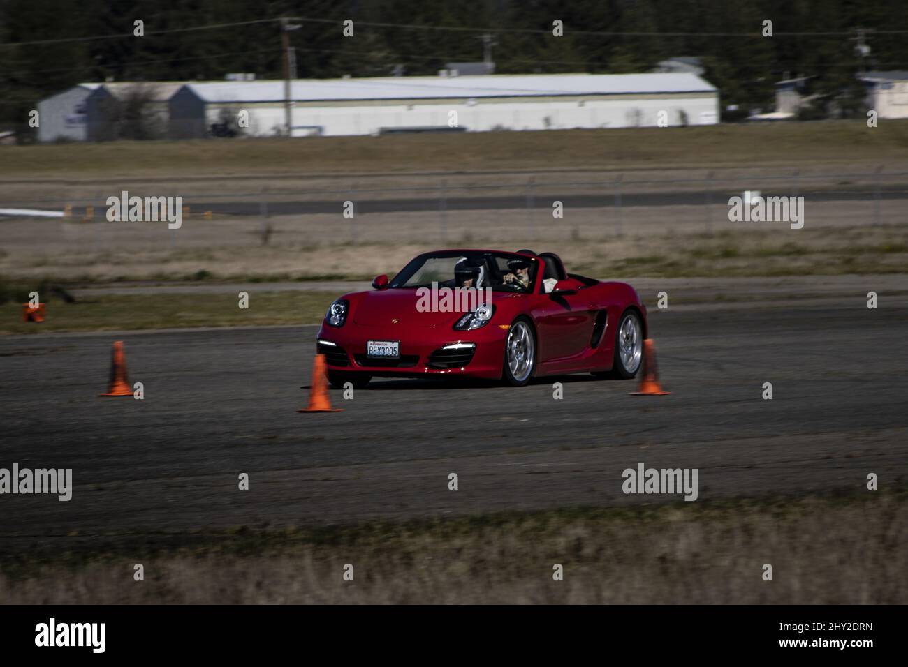 Red Porsche car racing on a runway in Washington Stock Photo - Alamy