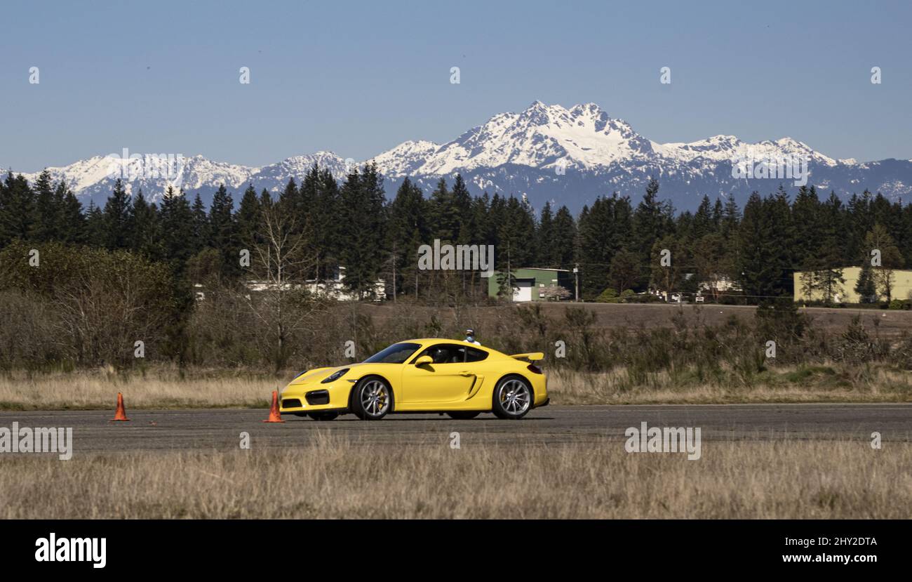 Yellow Porsche car racing on a runway in Washington Stock Photo - Alamy