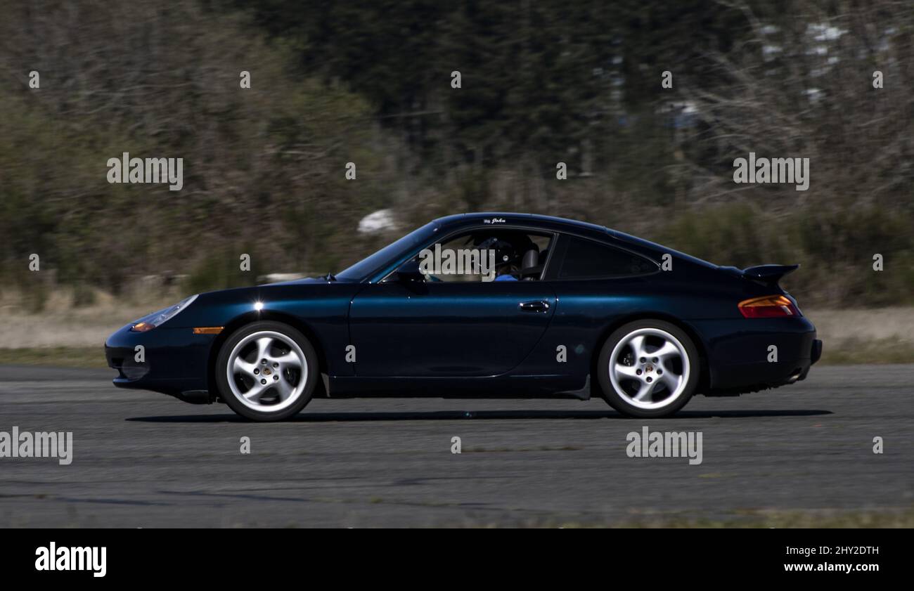 Blue Porsche car racing on a runway in Washington Stock Photo - Alamy