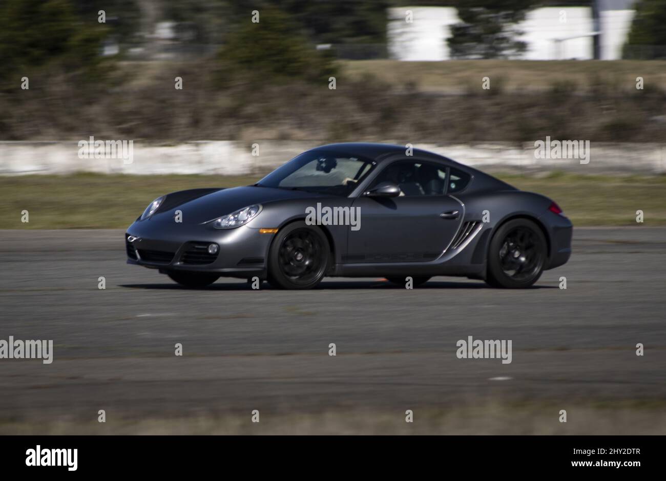 Dark gray Porsche car racing on a runway in Washington Stock Photo - Alamy
