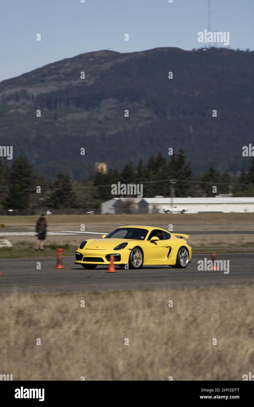 Yellow Porsche car racing on a runway in Washington Stock Photo - Alamy