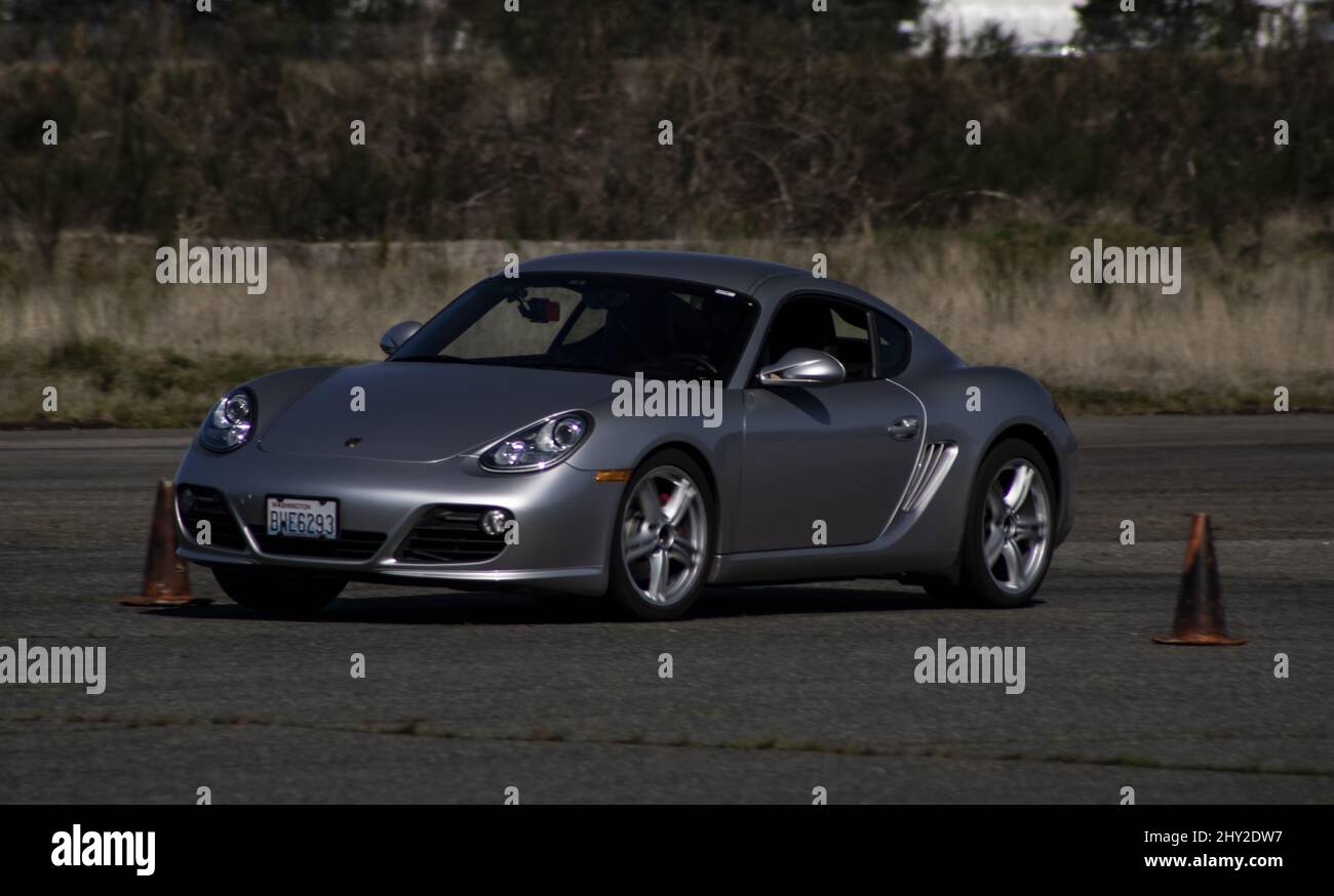 Dark gray Porsche car racing on a runway in Washington Stock Photo - Alamy