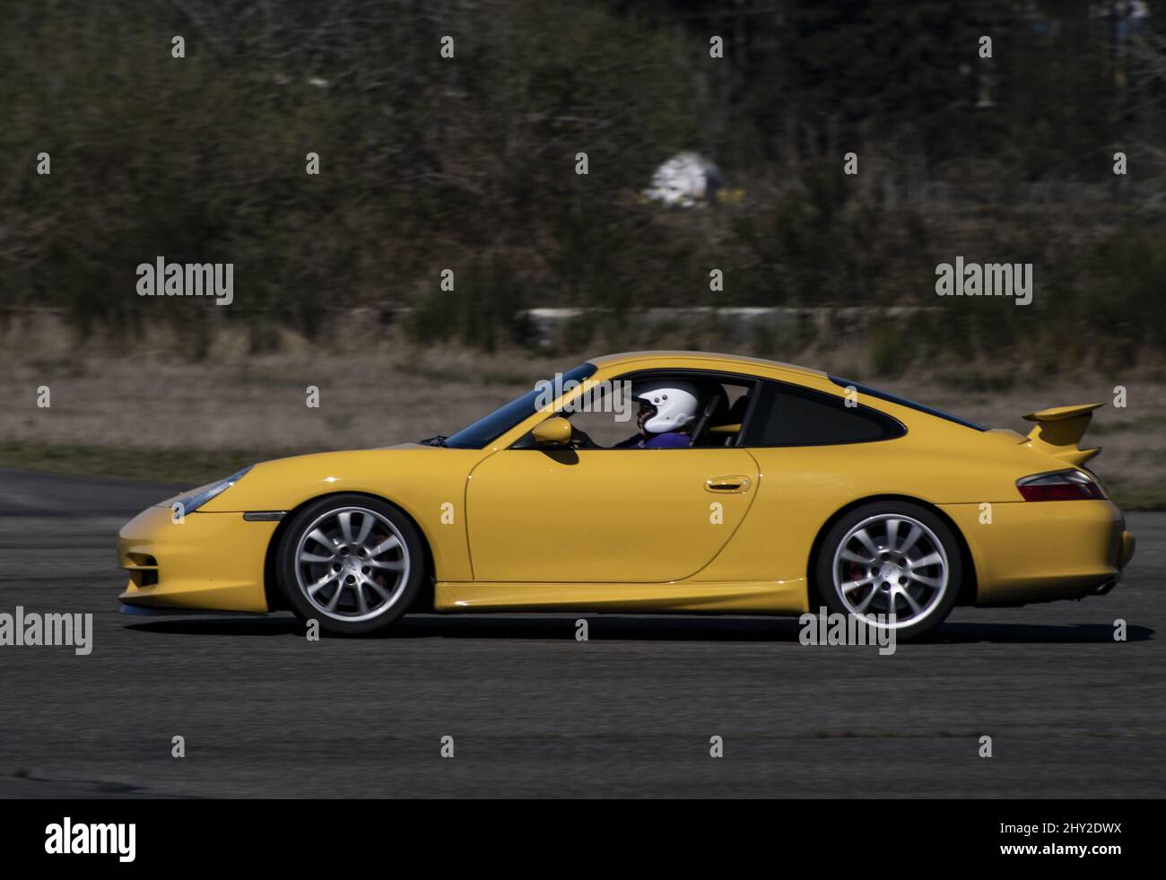 Yellow Porsche car racing on a runway in Washington Stock Photo - Alamy