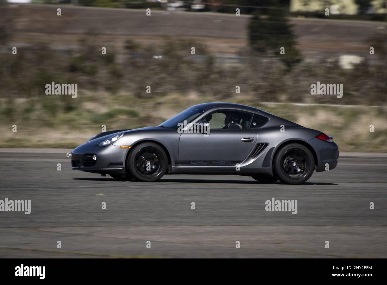 Dark gray Porsche car racing on a runway in Washington Stock Photo - Alamy