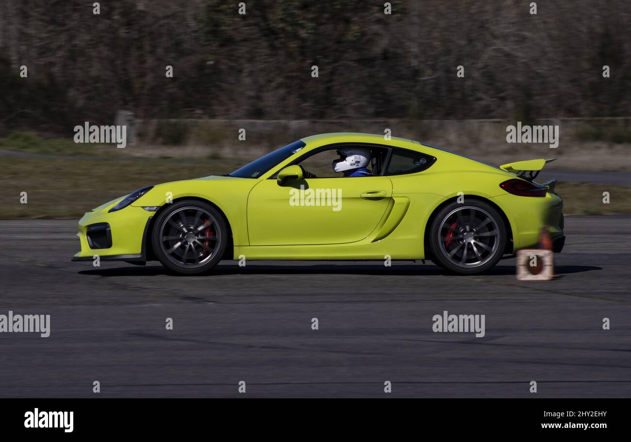 Yellow Porsche car racing on a runway in Washington Stock Photo - Alamy