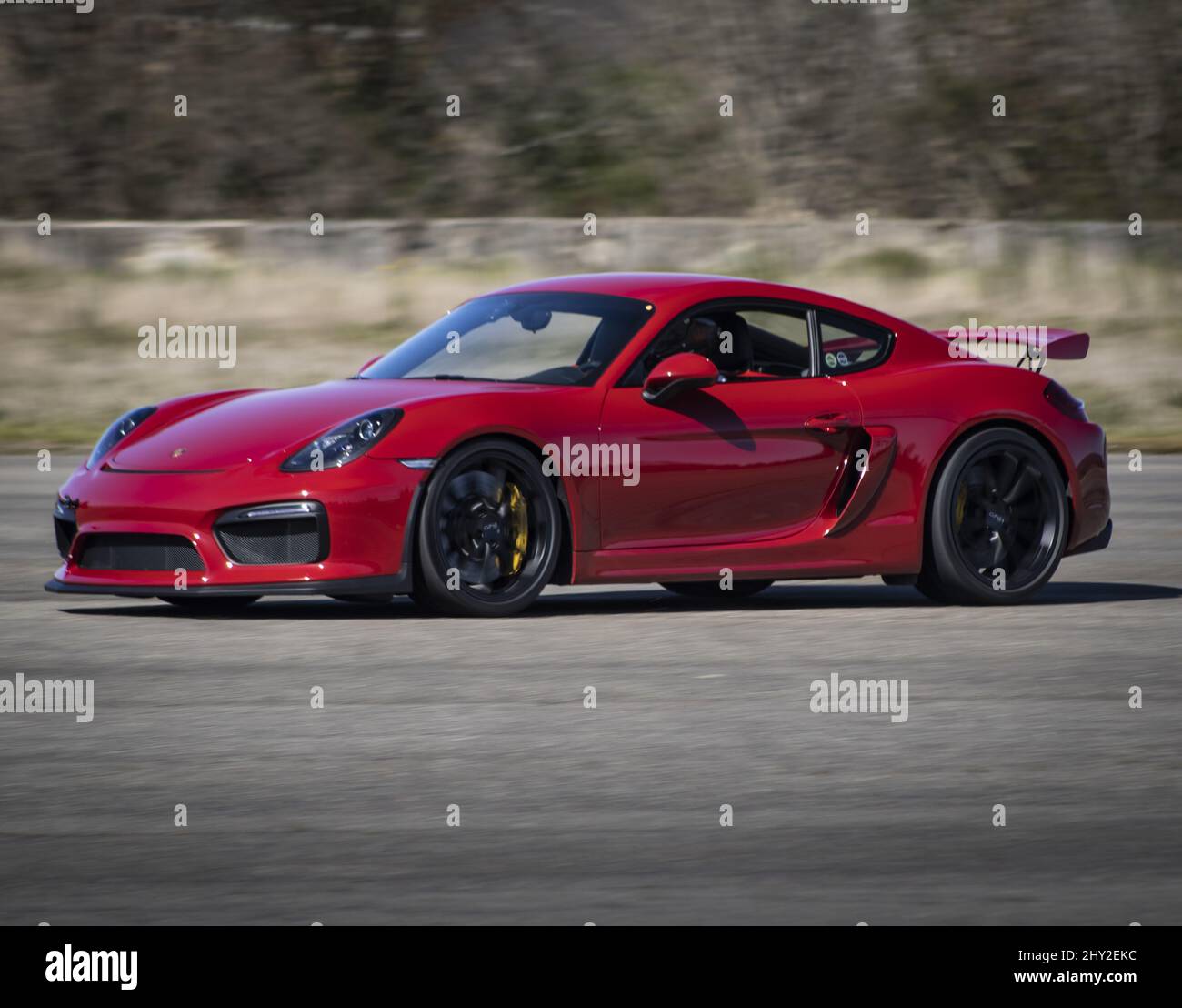 Red Porsche car racing on a runway in Washington Stock Photo - Alamy
