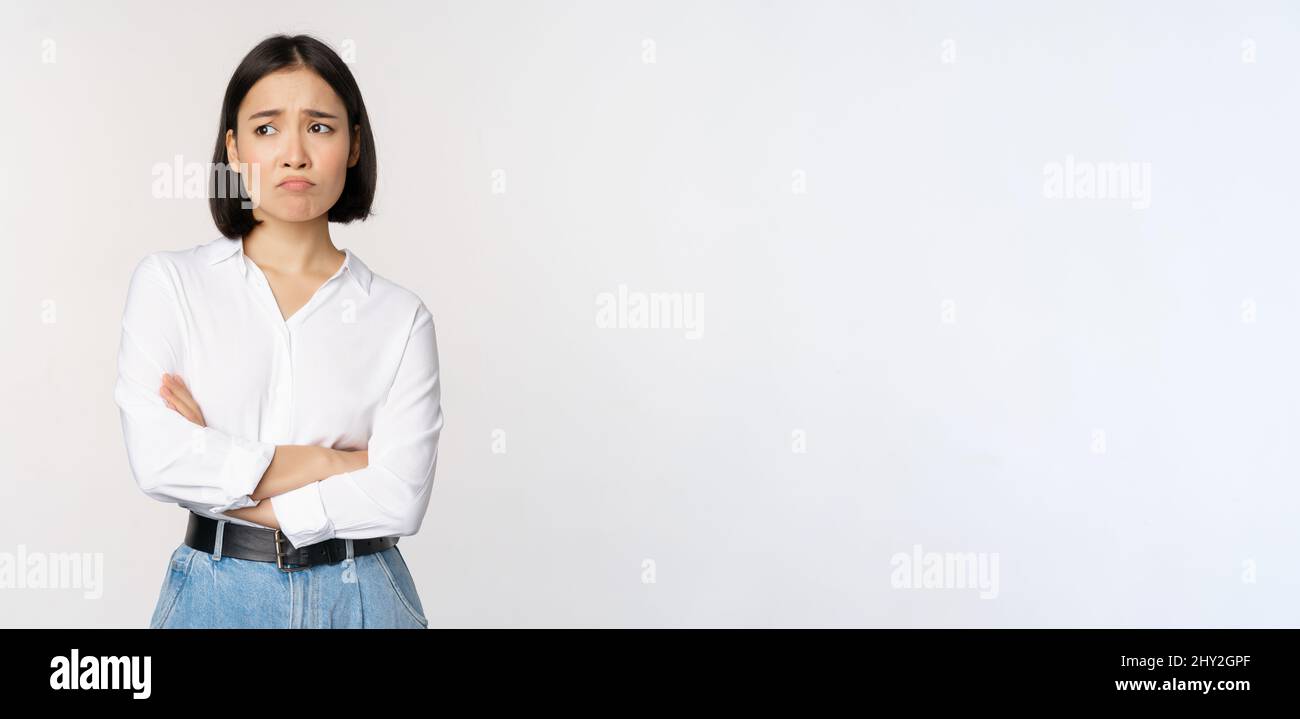 Image of sad office girl, asian woman sulking and frowning disappointed ...