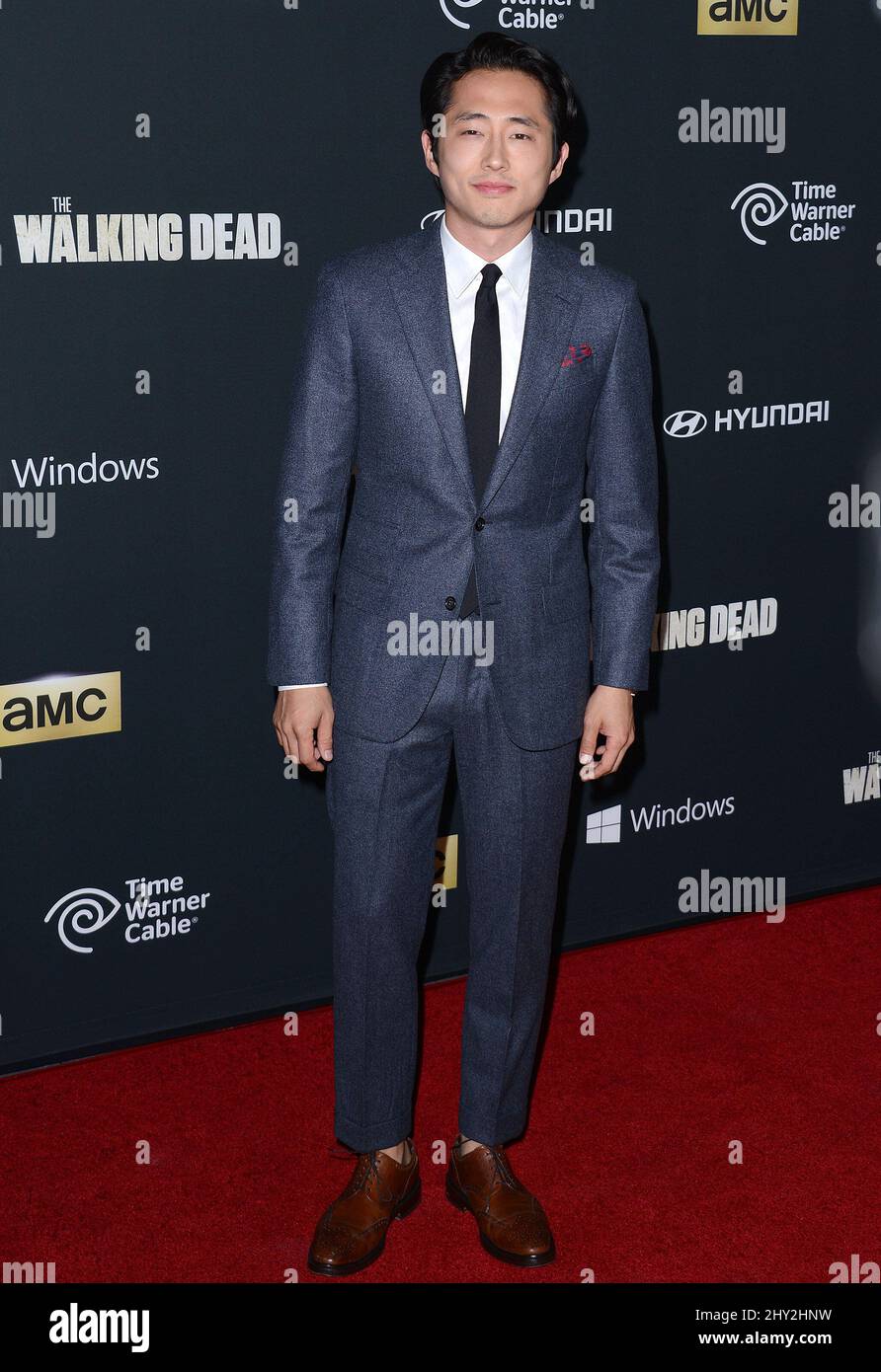 Steven Yeun attending the season four premiere of "The Walking Dead" in ...