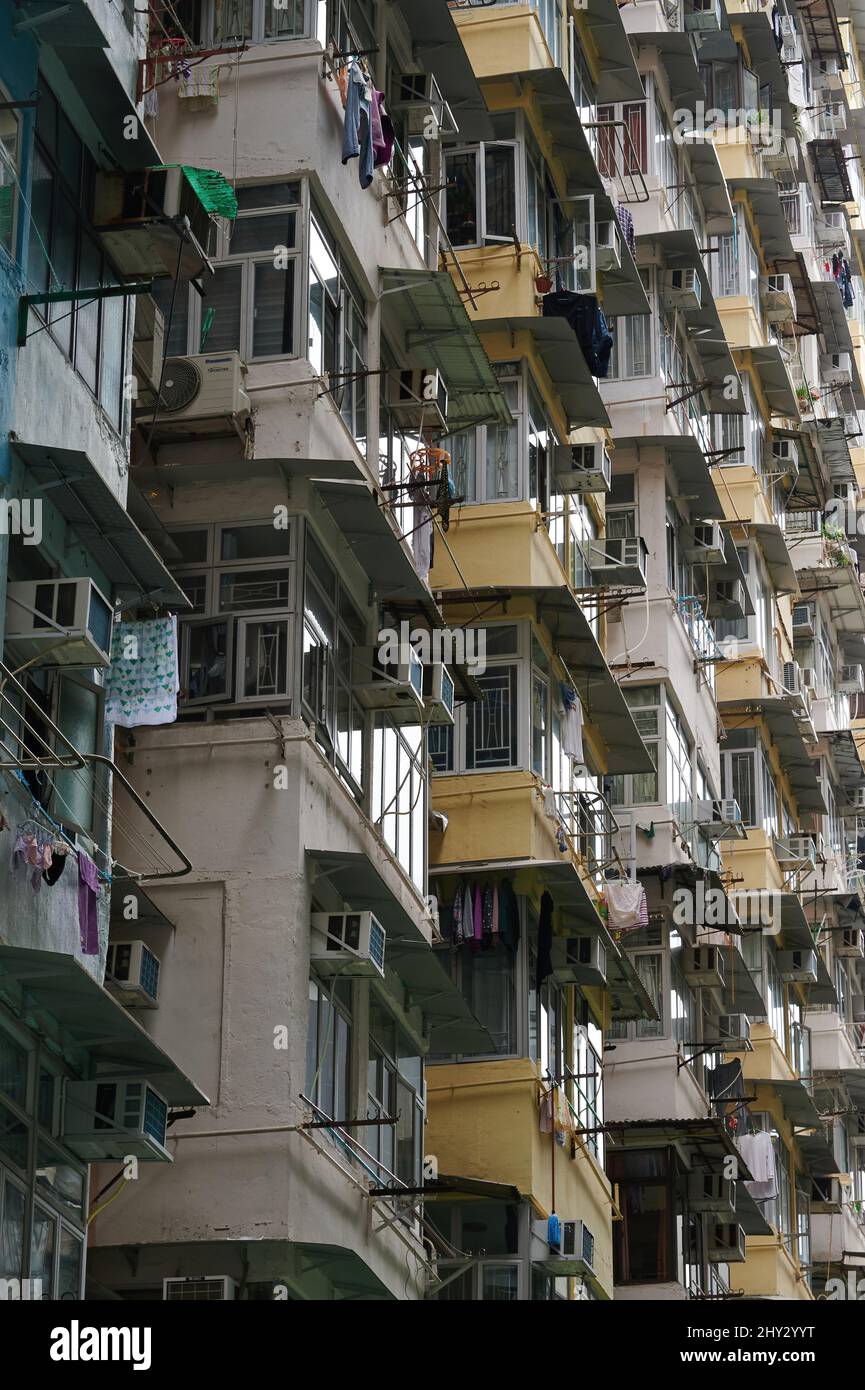 Vertical shot of a residential building with colorful balconies in Hong ...