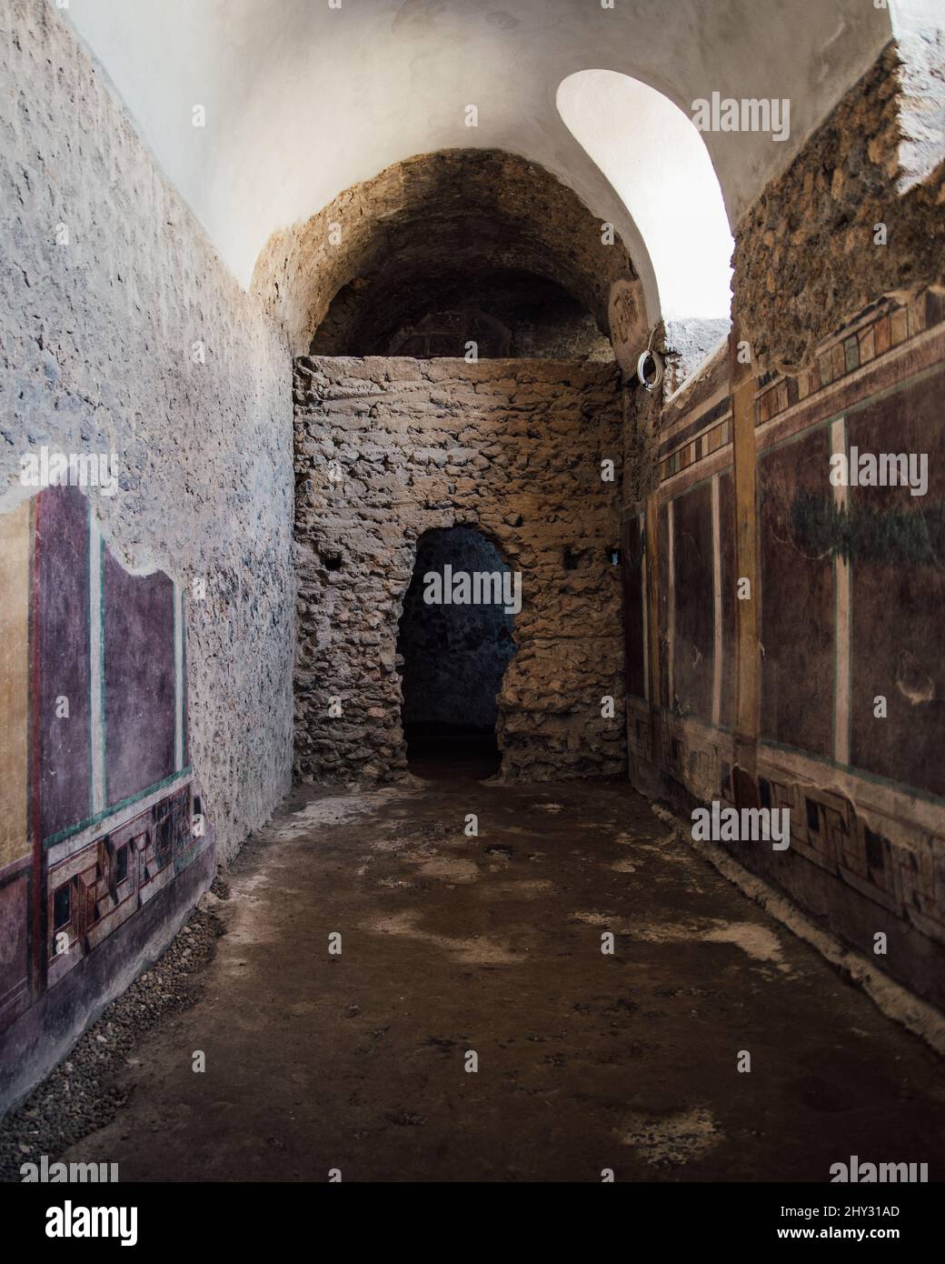 View of a corridor in an ancient building with worn out walls and ...