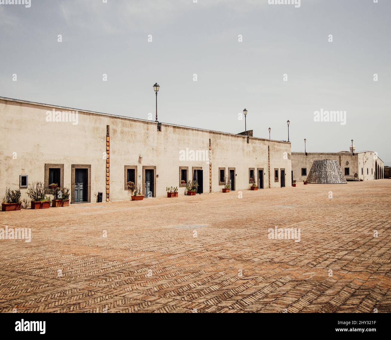 Perspective shot of a one-story building with the same doors and widows ...