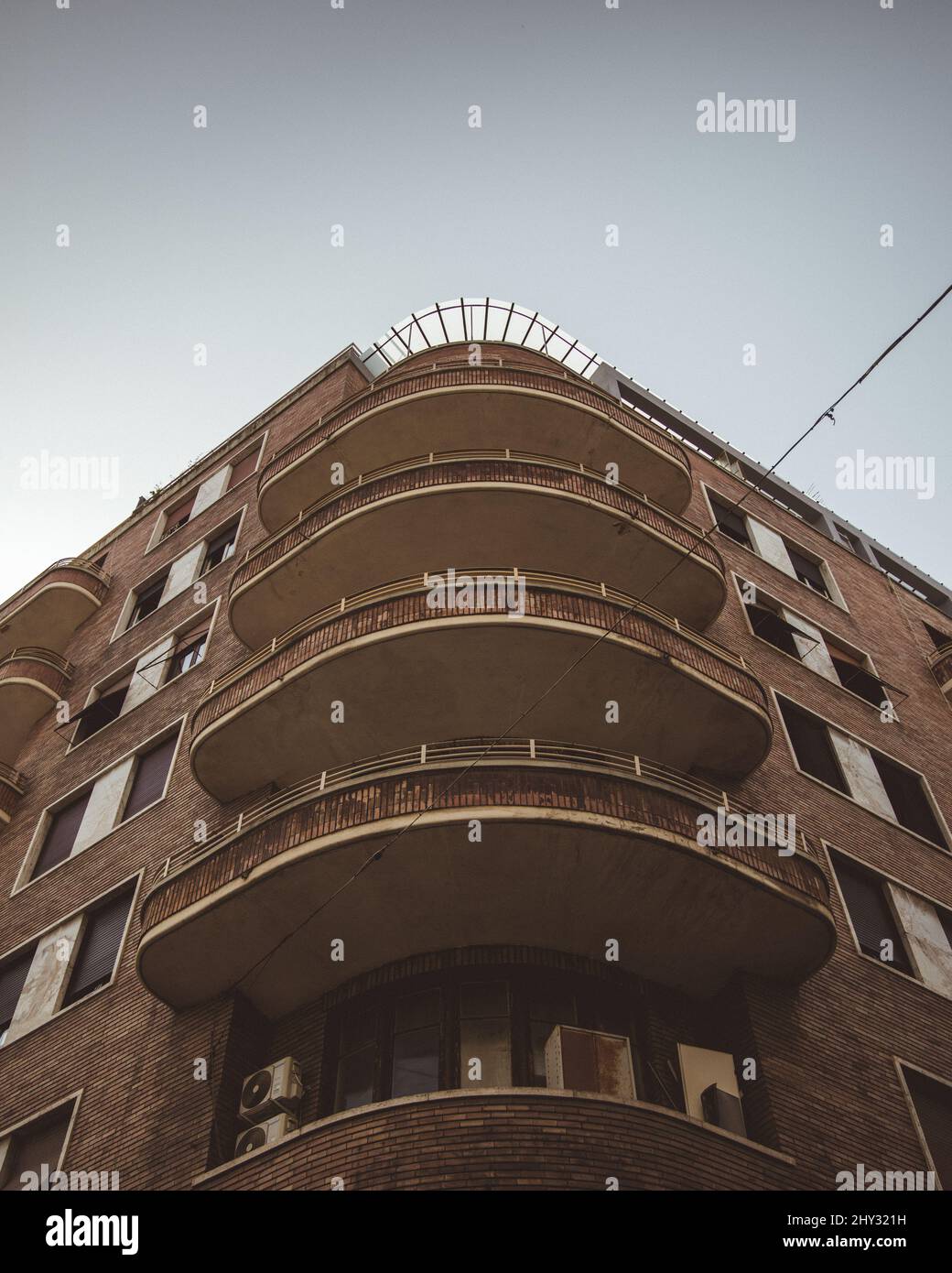 Vertical bottom shot of a building angle with round-shaped balconies ...