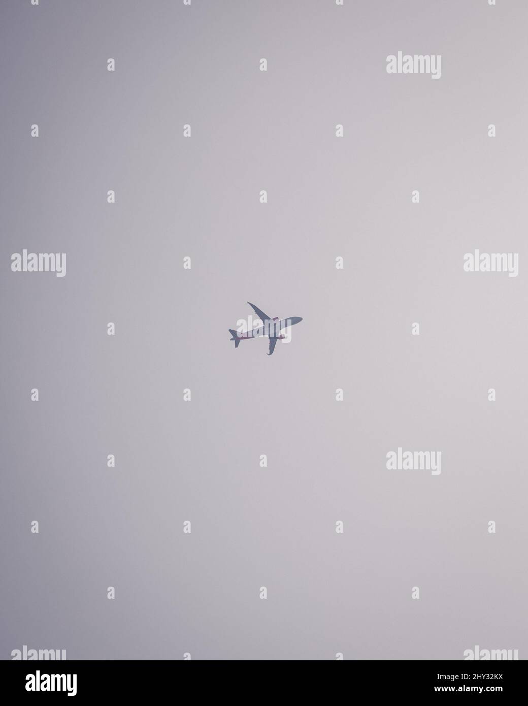 Vertical shot of an airplane flying in the sky Stock Photo - Alamy