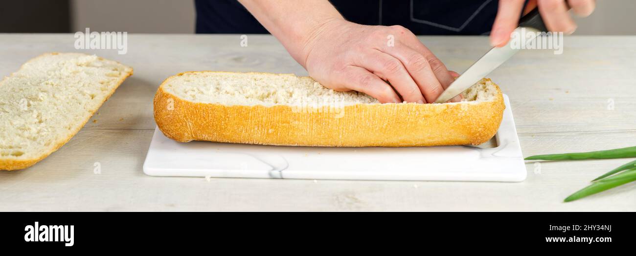 the cook cuts fresh ciabatta bread. Pulls out the pulp from the inside ...