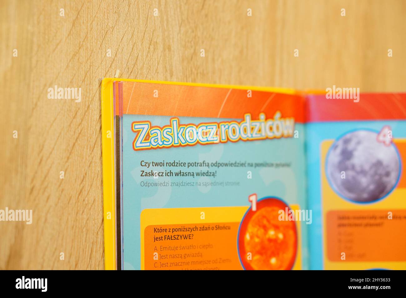 Open Polish National Geographic book for kids about planets on a table ...