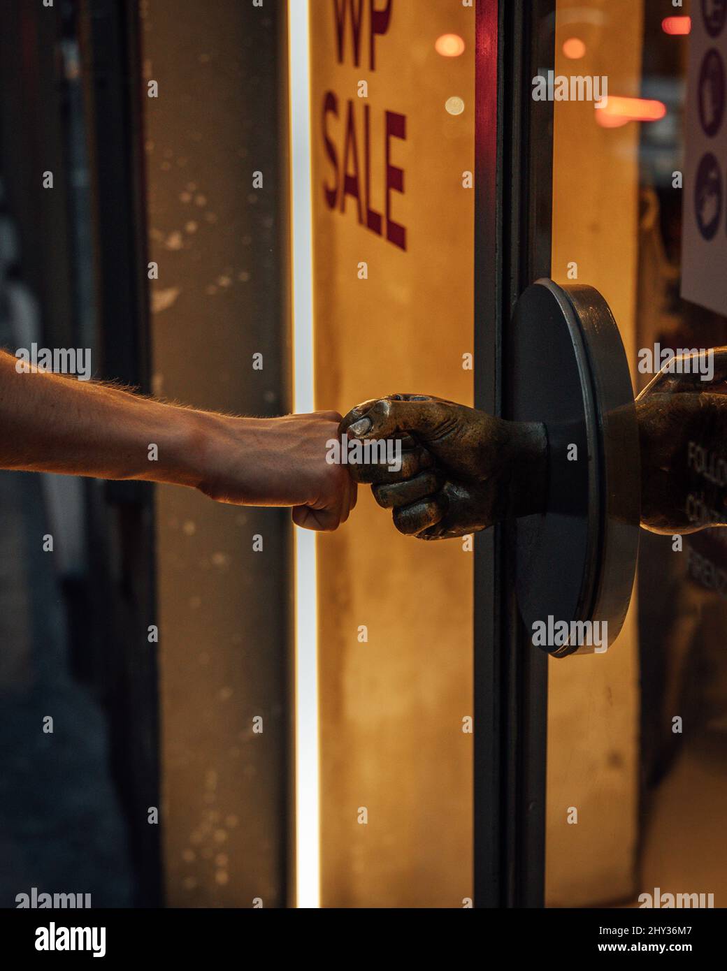 Vertical shot of a man hand hitting with a fist of a stone made fist ...