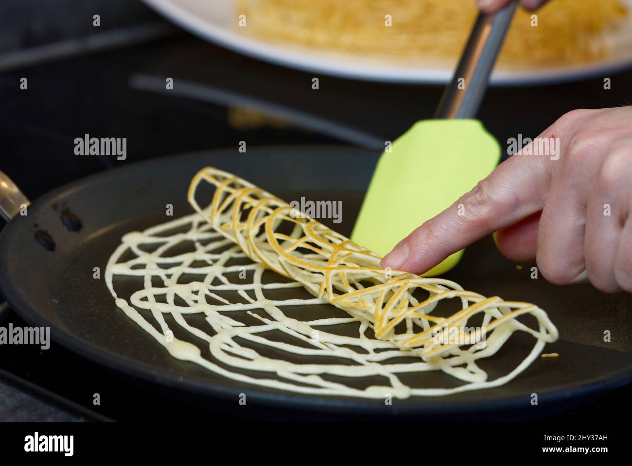 Cooking net pancakes at home. unusual street food. Roti Jala malaysian ...