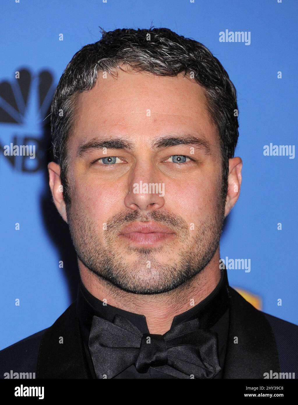 Taylor Kinney poses in the press room at the 71st annual Golden Globe ...