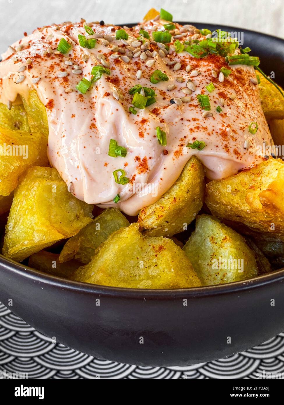 Closeupof a native Spanish dish called Patatas Bravas in a bowl Stock ...