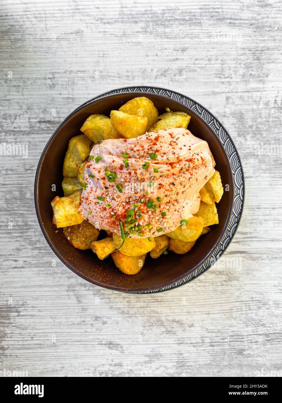 Top view of a native Spanish dish called Patatas Bravas in a bowl Stock ...
