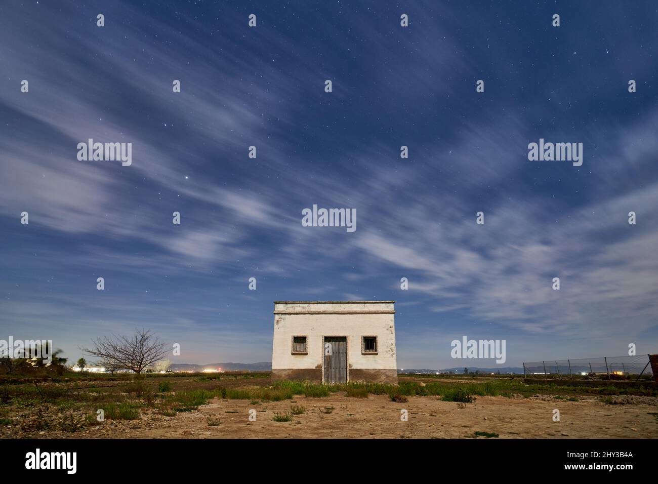 View of a single-storey stone building in the middle of a green field ...