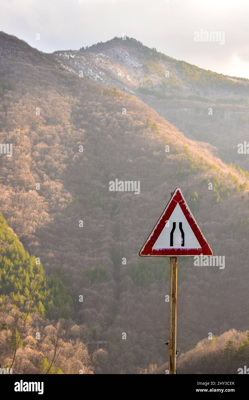 Vertical shot of a road narrowing sign Stock Photo - Alamy