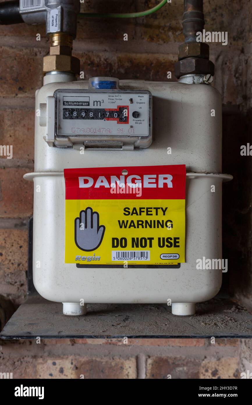 A gas meter with a danger safety warning sticker Stock Photo - Alamy