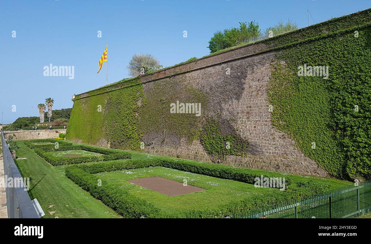 Wall with a flag of the Montjuic Castle in Barcelona, Spain, under the ...