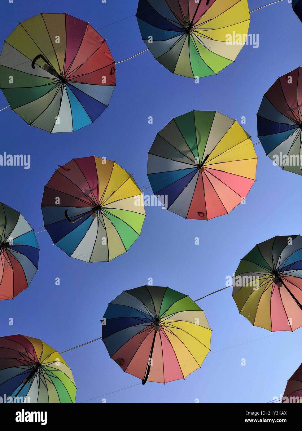 Angle photo of colorfull umbrellas hanging in air Stock Photo - Alamy