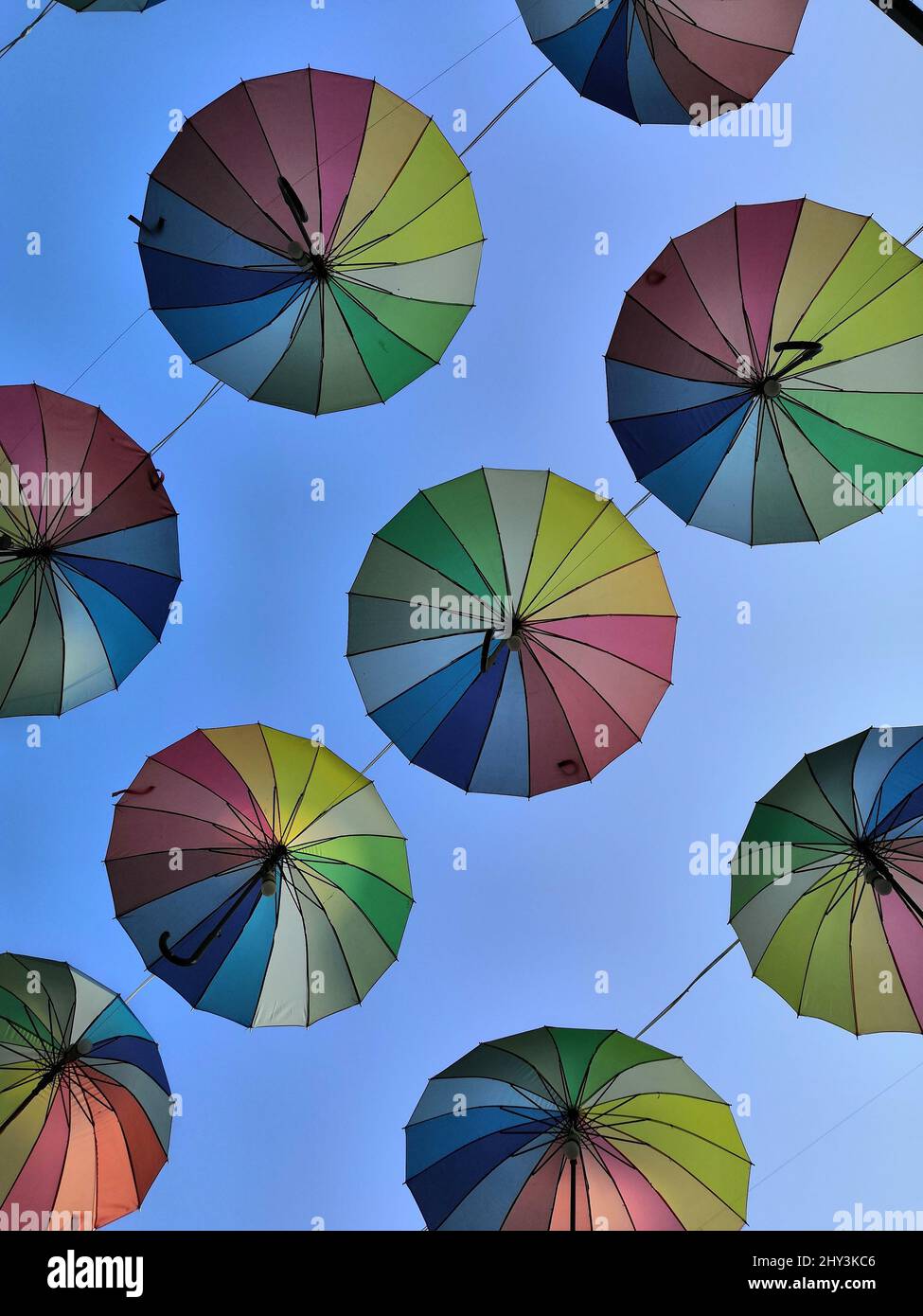 Angle photo of colorfull umbrellas hanging in air Stock Photo - Alamy