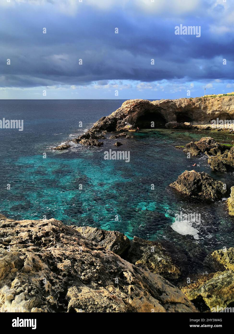 Photo of rocks going into the ocean Stock Photo - Alamy